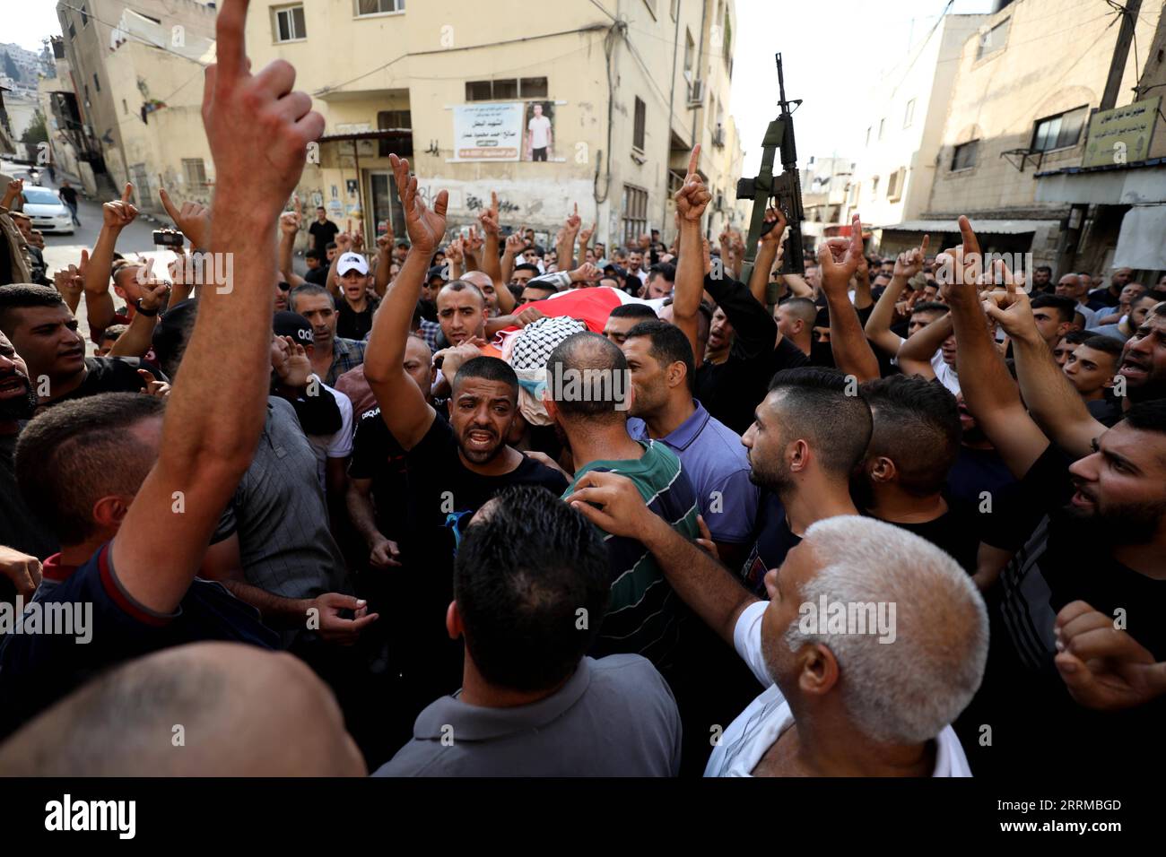 221014 -- JENIN, Oct. 14, 2022 -- Mourners carry the body of a ...