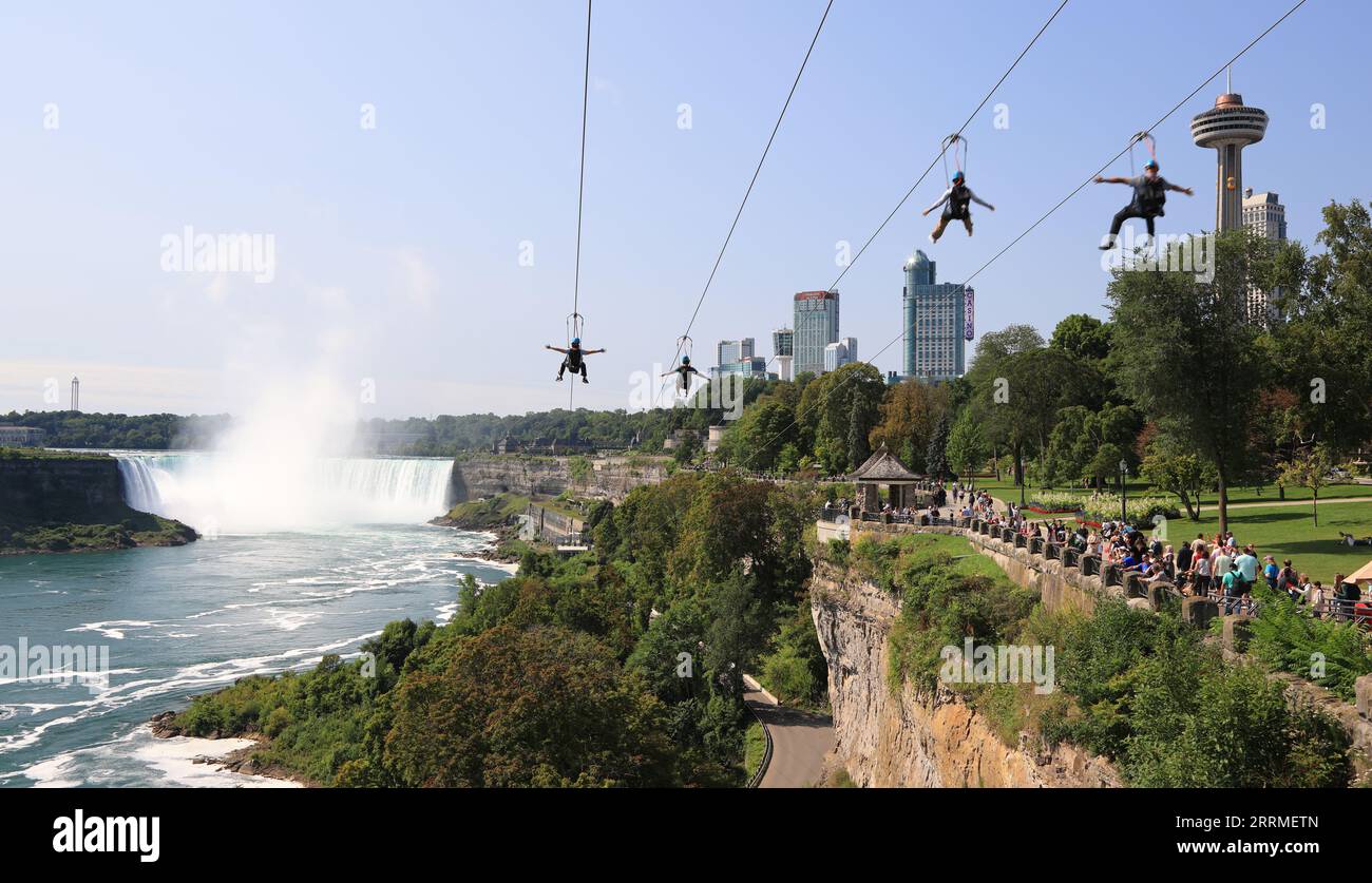 Tourists enjoying zipline ride at Niagara Falls in summer Stock Photo ...