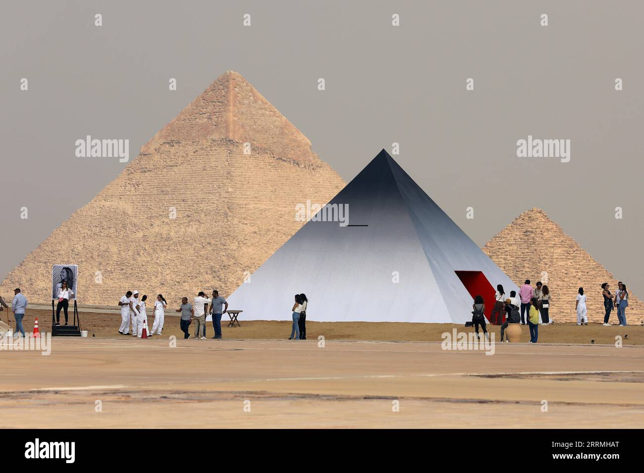 221031 -- GIZA, Oct. 31, 2022 -- People visit a pyramid-shaped artwork ...