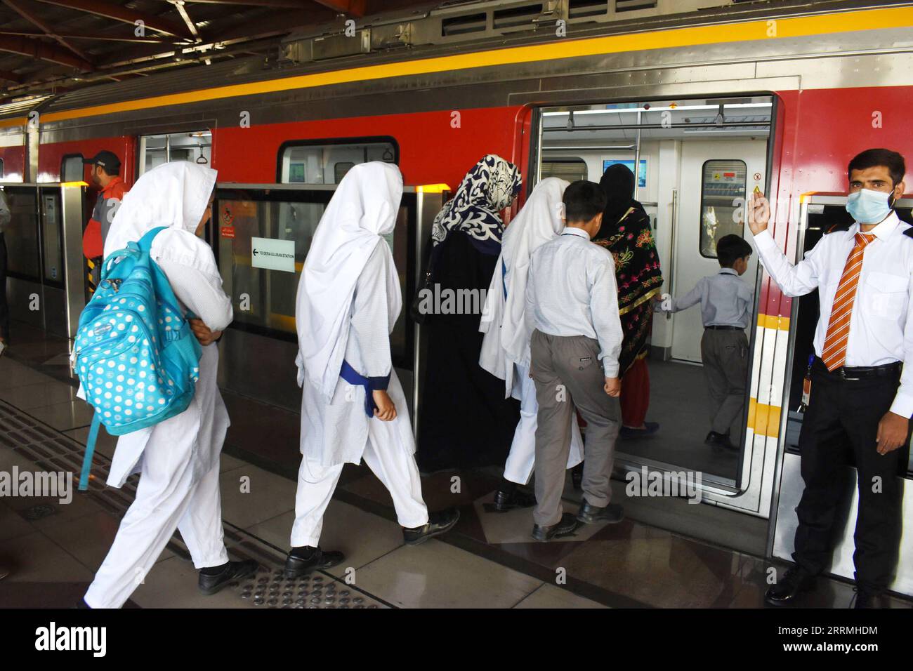 221031 -- LAHORE, Oct. 31, 2022 -- Passengers board an Orange Line ...