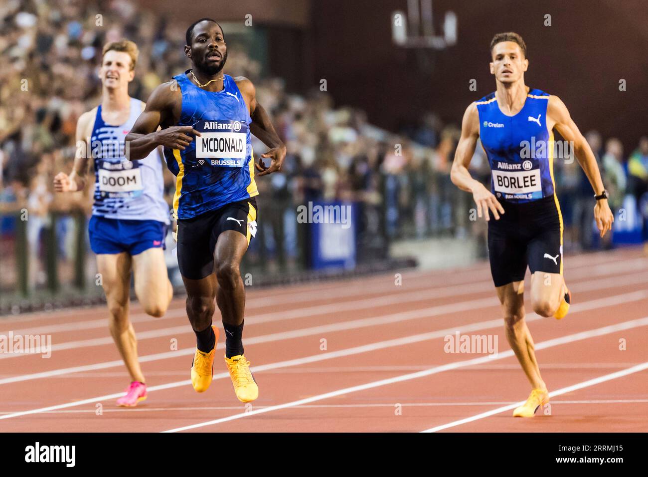 Rusheen McDonald from Jamaica, center, crosses the finish line to win ...