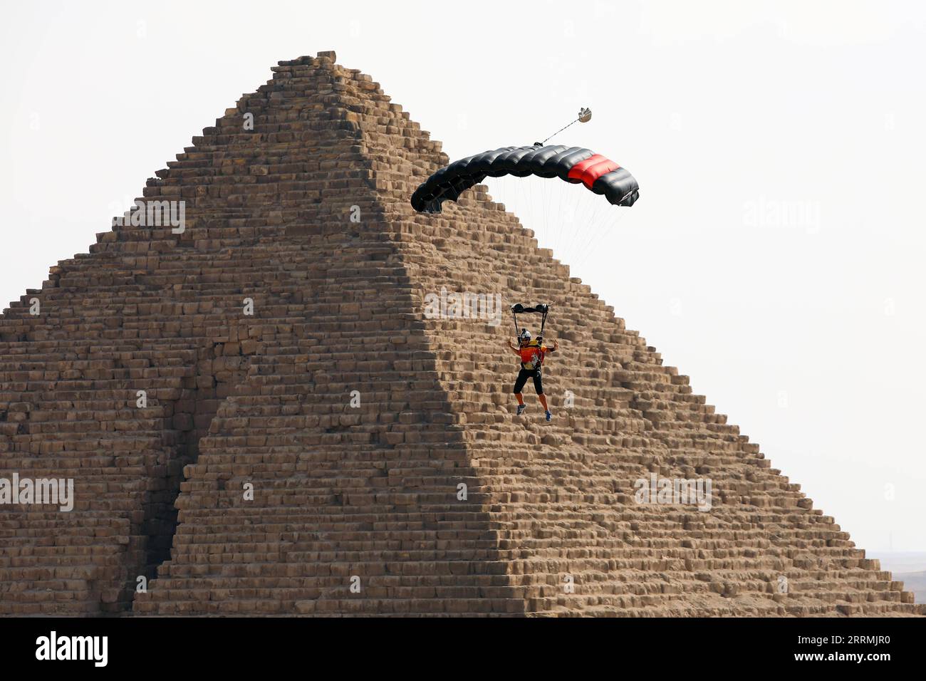 221103 -- CAIRO, Nov. 3, 2022 -- A skydiver flies by a pyramid during ...