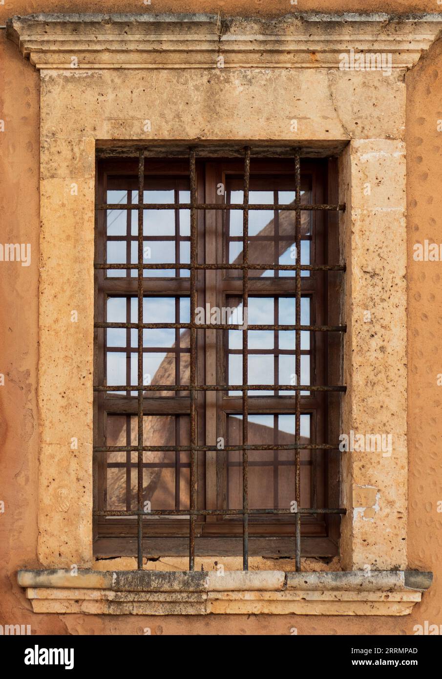A white brick building with a small window located in the upper corner ...