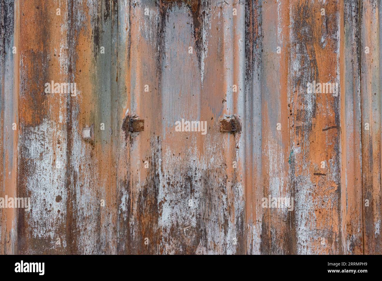 Steel metal wall with various stages of rusting and paint decomposition ...
