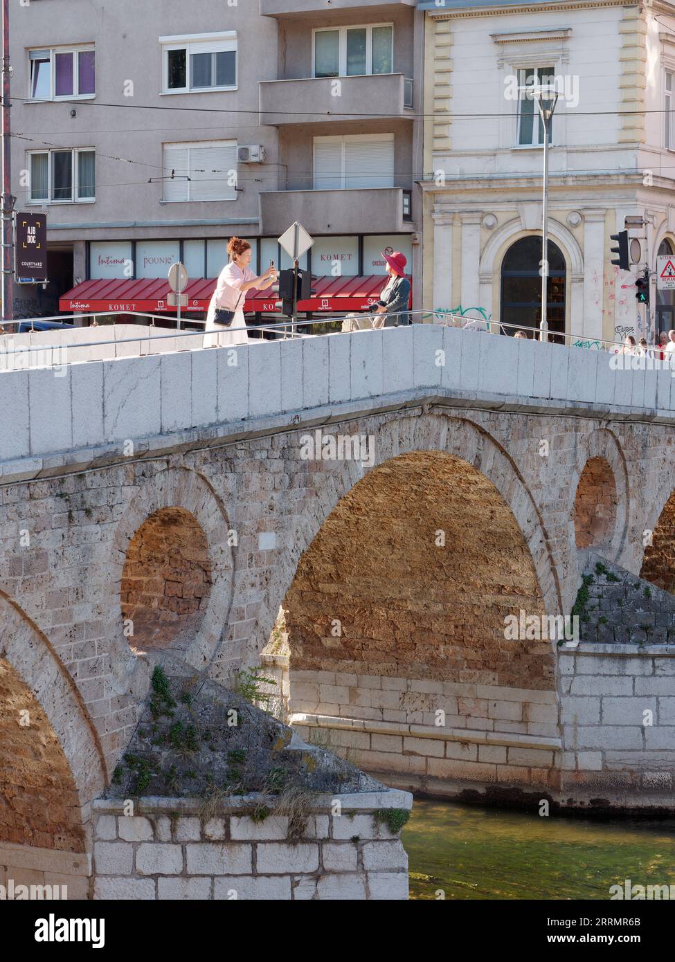 Tow women on the famous Latin Bridge over the Rivrer Miljacka on a ...