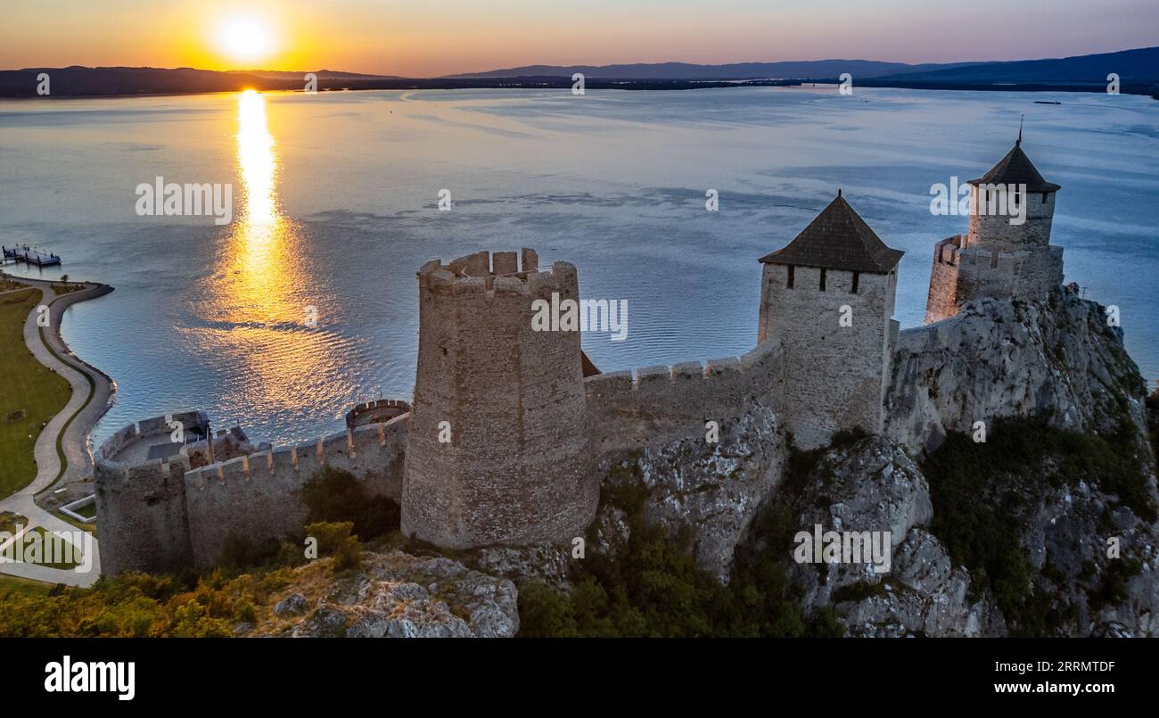 Golubac fortress castle walls standing on Danube river bank in sunset ...