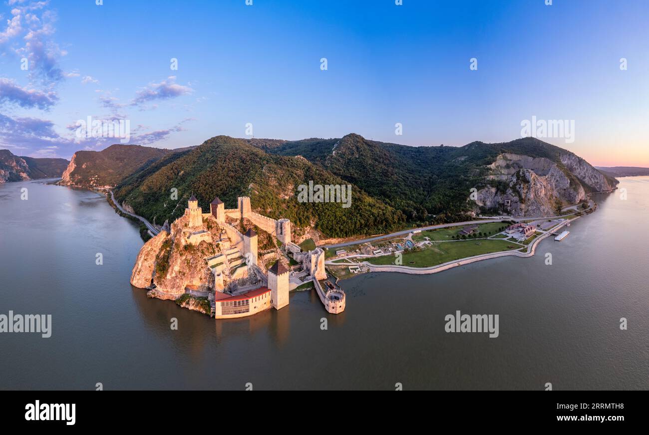 Golubac fortress castle walls standing on Danube river bank in sunset ...