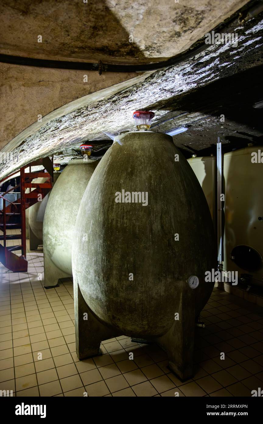 Concrete tanks eggs for fermentation process. Visit of undergrounds ...