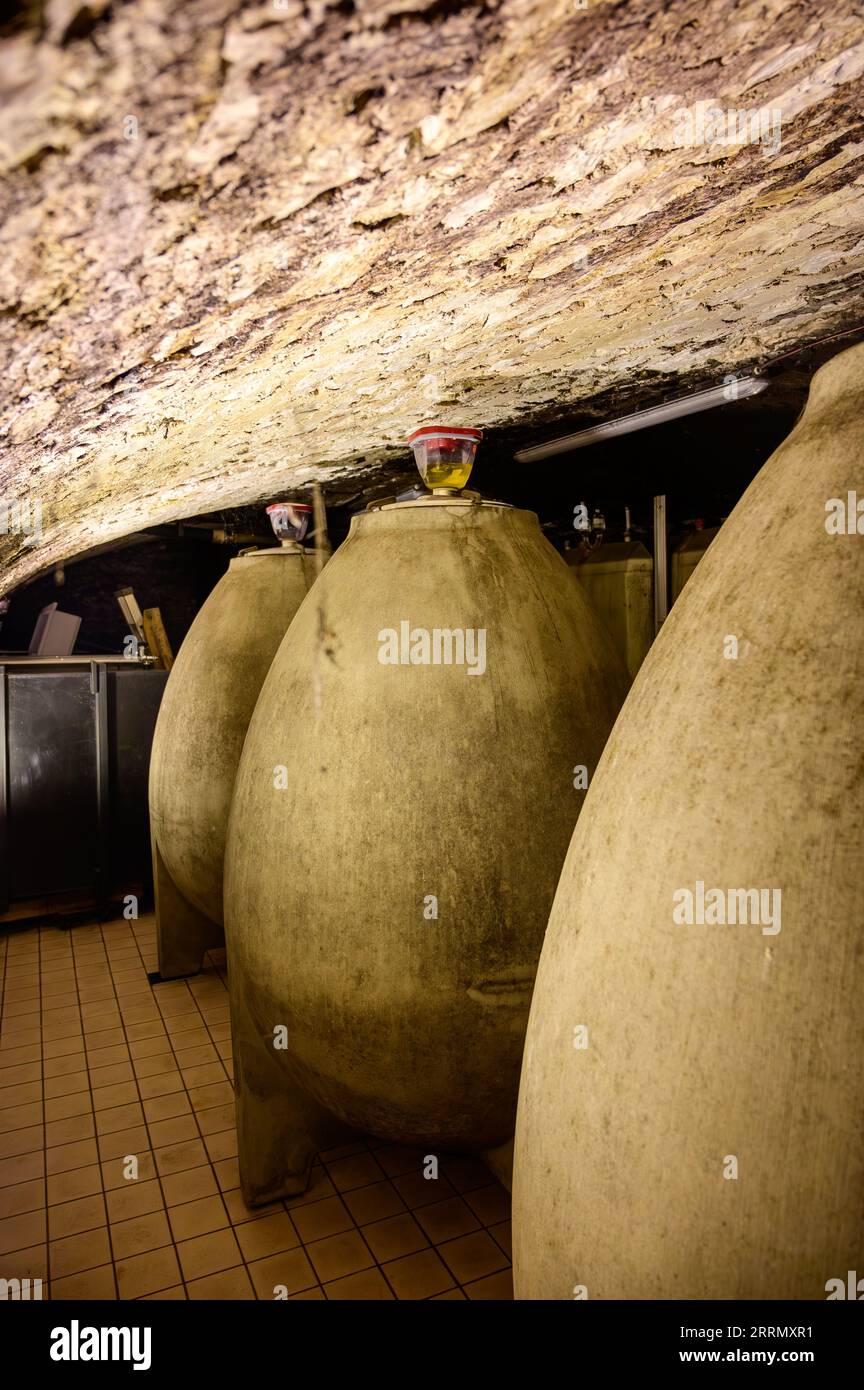 Concrete tanks eggs for fermentation process. Visit of undergrounds ...