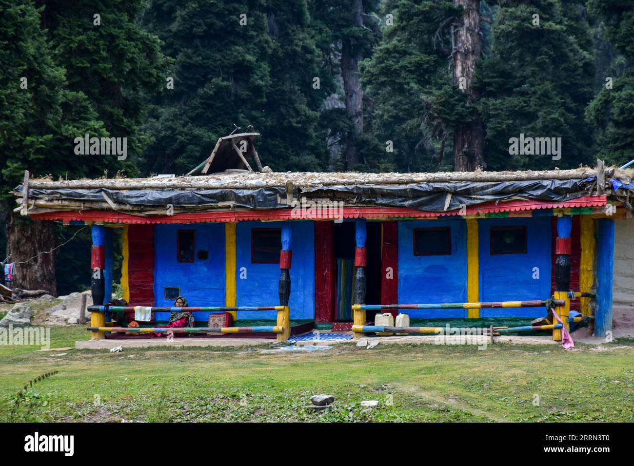 A Kashmiri nomad woman rests outside her mud house in Bota Pathri, a ...
