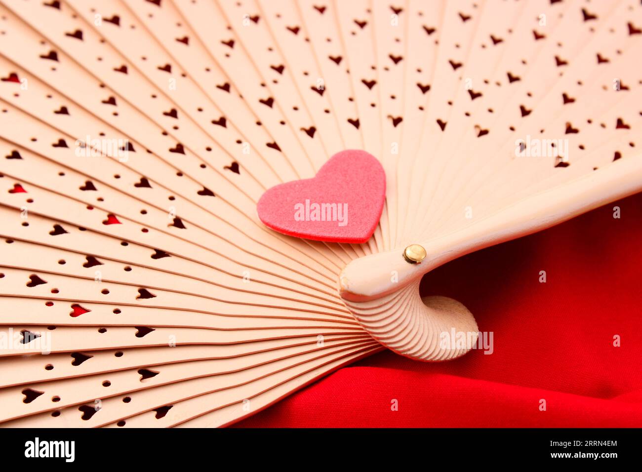 Wooden fan structure with openwork hearts Stock Photo - Alamy