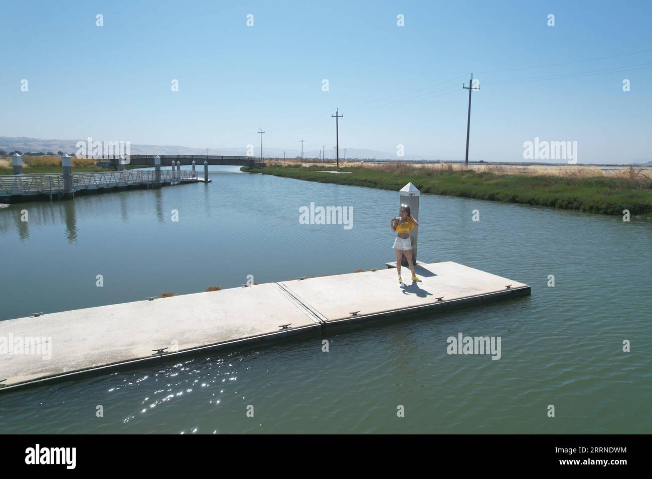 Photo of a beautiful Arab lady on a dock, on a river, photographed from ...