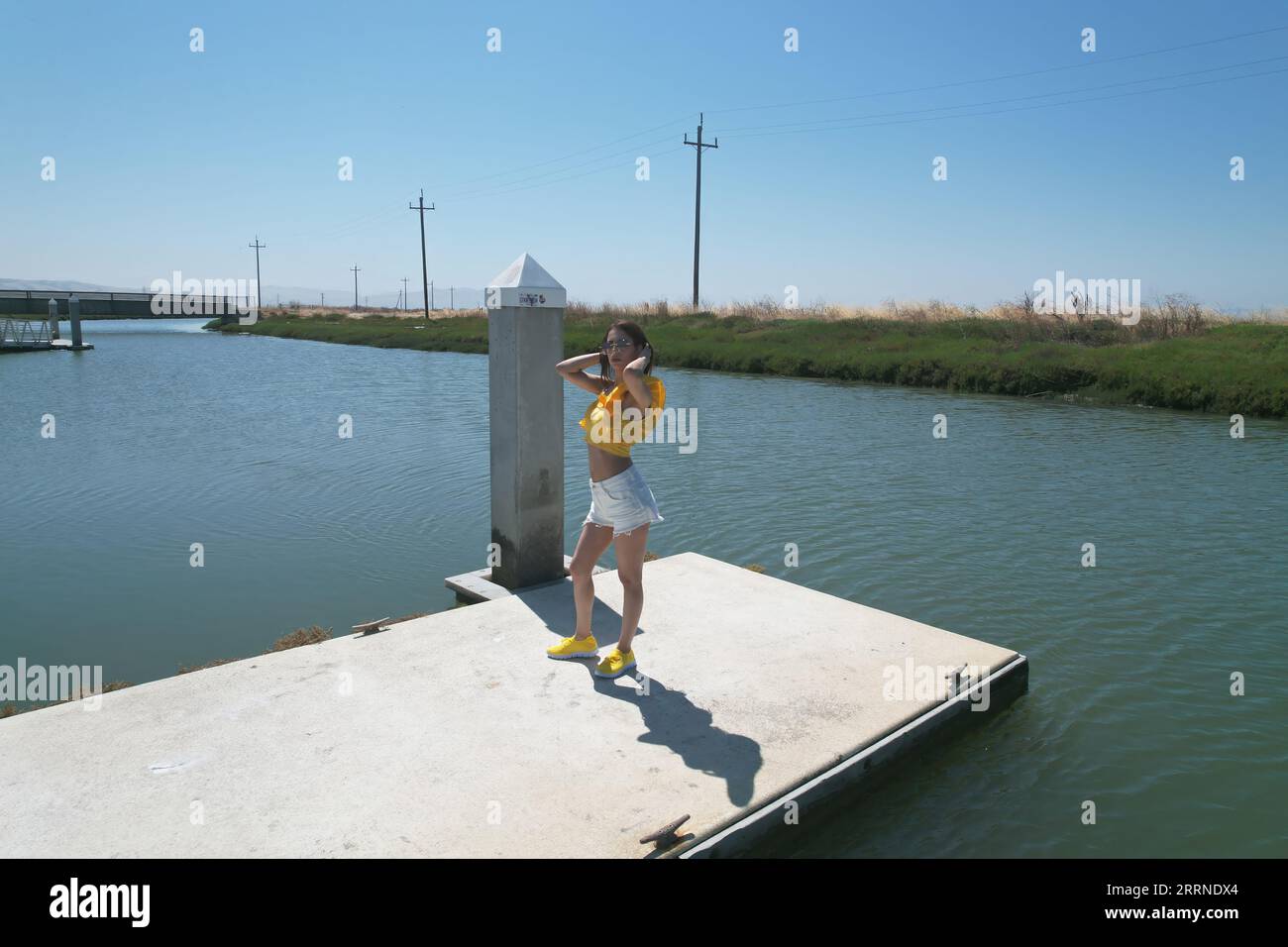 Photo of a beautiful Arab lady on a dock, on a river, photographed from ...