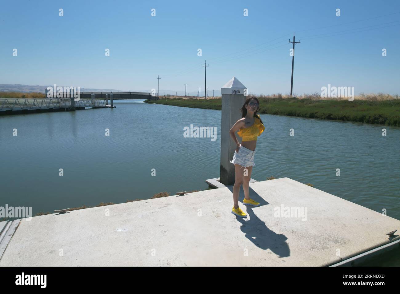 Photo of a beautiful Arab lady on a dock, on a river, photographed from ...