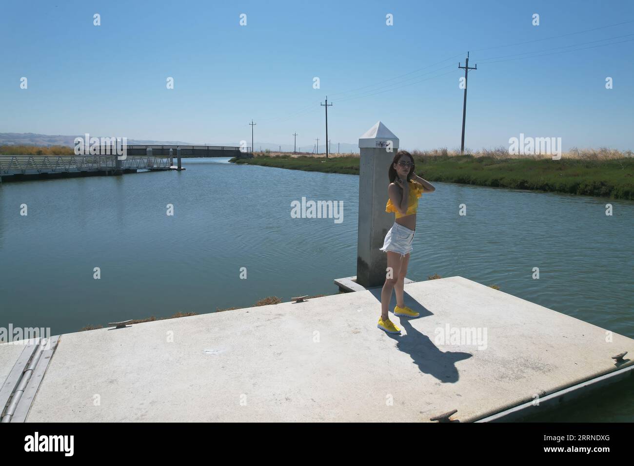Photo of a beautiful Arab lady on a dock, on a river, photographed from ...