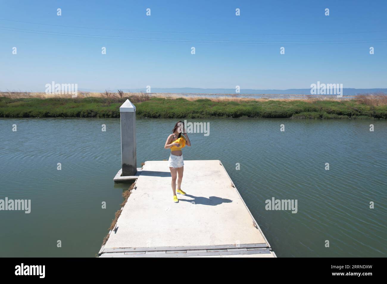 Photo of a beautiful Arab lady on a dock, on a river, photographed from ...