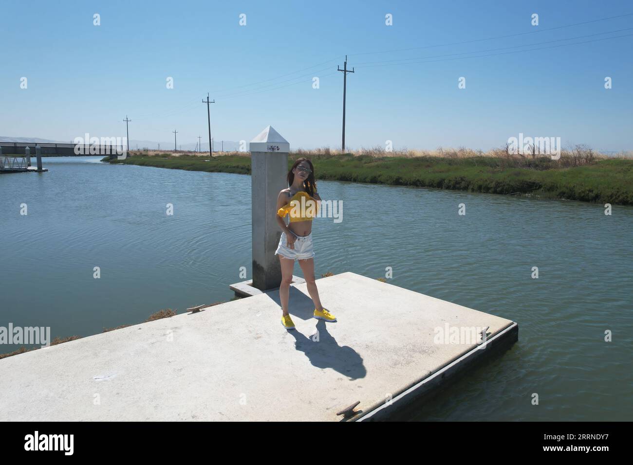 Photo of a beautiful Arab lady on a dock, on a river, photographed from ...