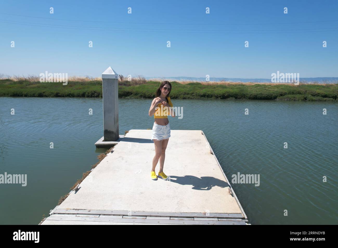 Photo of a beautiful Arab lady on a dock, on a river, photographed from ...