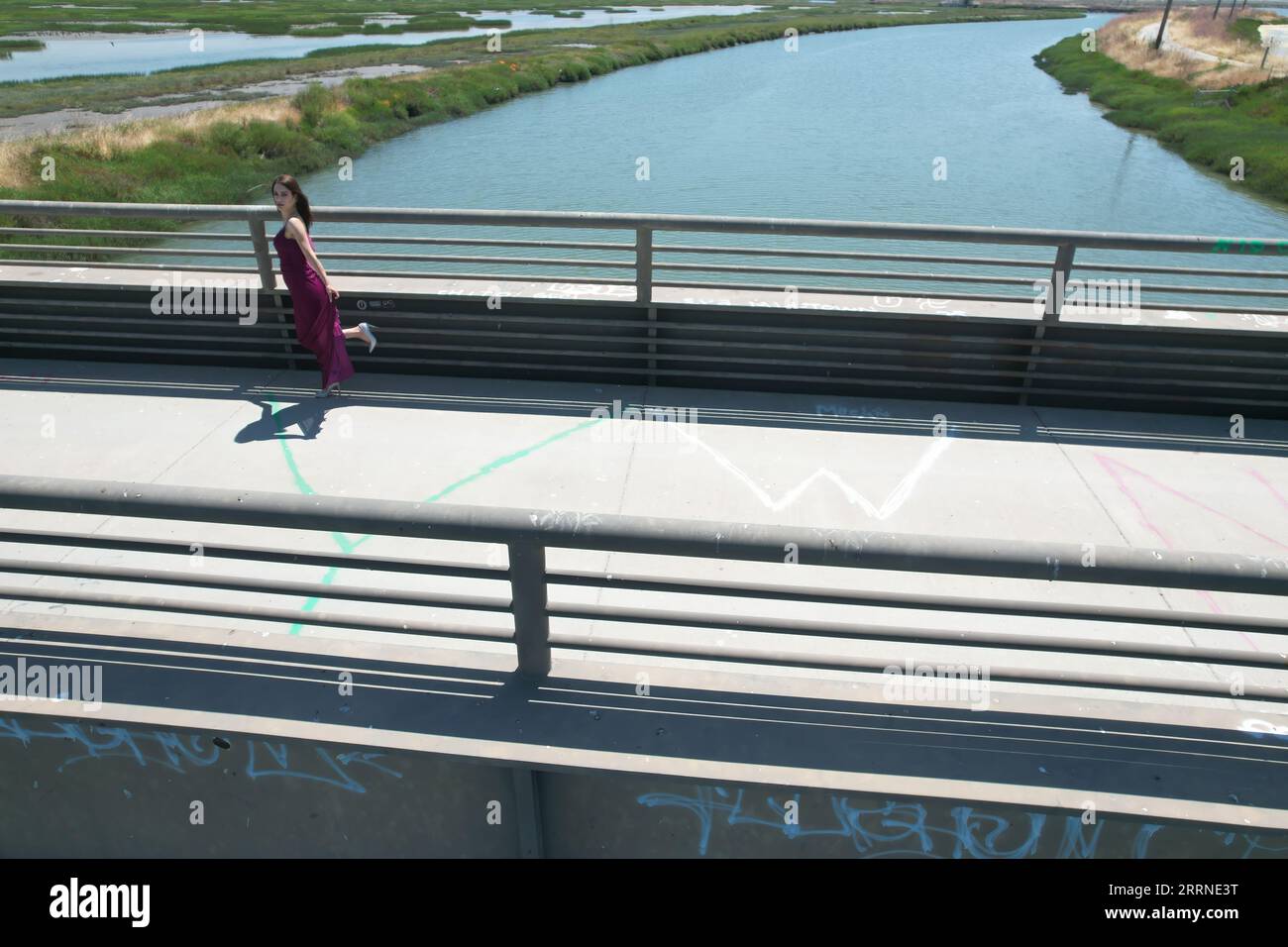 Photo of a beautiful Arab lady on a dock, on a river, photographed from ...