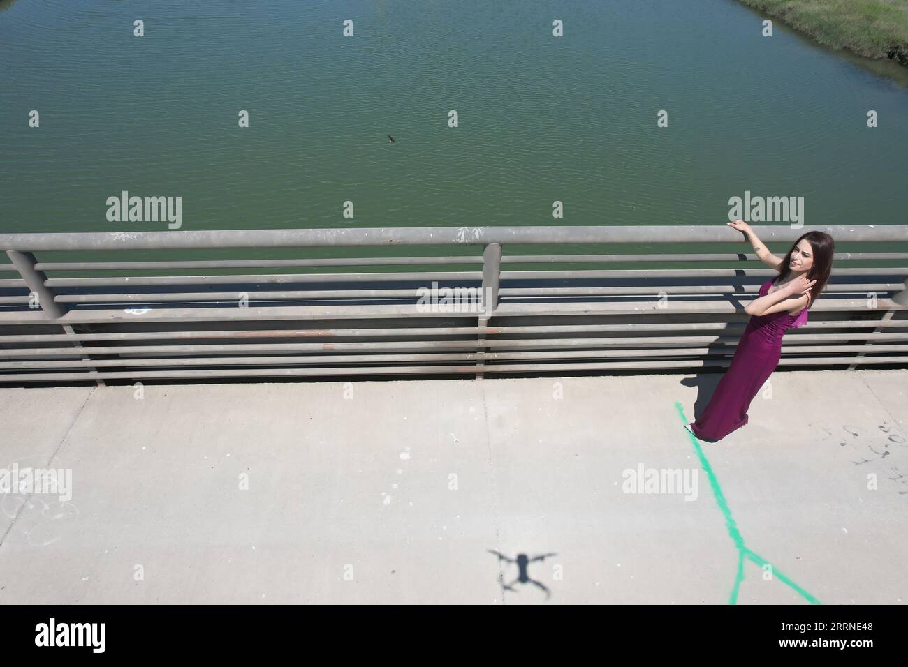Photo of a beautiful Arab lady on a dock, on a river, photographed from ...
