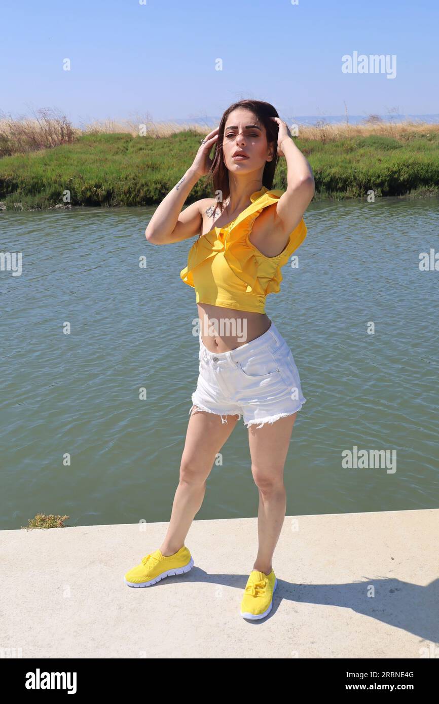 Photo of a beautiful Arab lady on a dock, on a river Stock Photo - Alamy