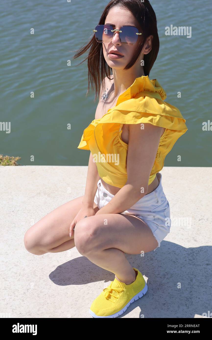 Photo of a beautiful Arab lady on a dock, on a river Stock Photo - Alamy