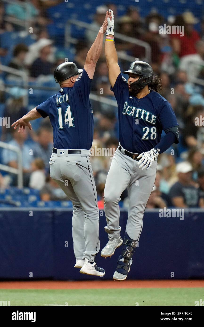 Seattle Mariners' Eugenio Suarez (28) celebrates with third base coach ...