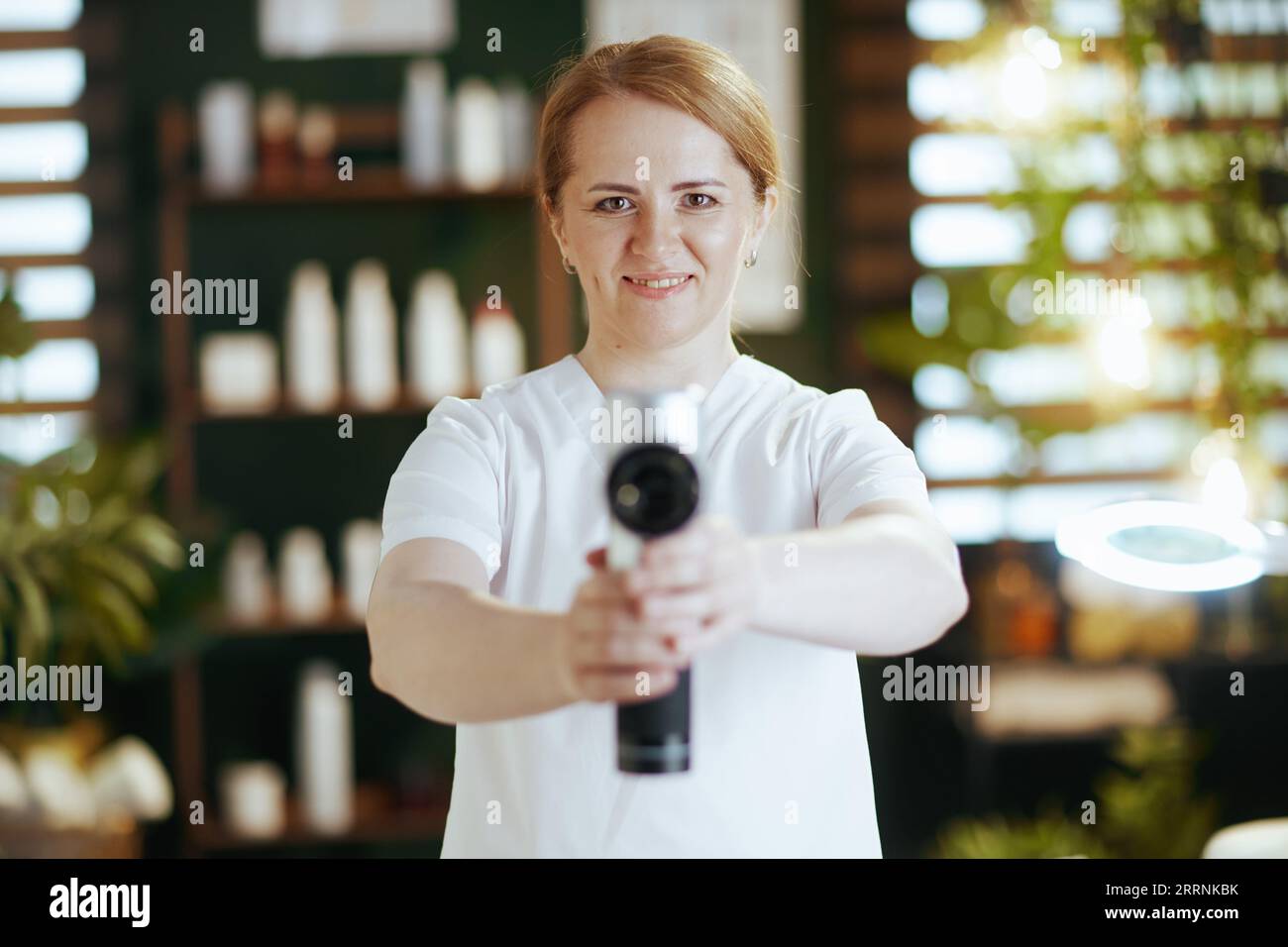 Healthcare time. happy female medical massage therapist in spa salon ...