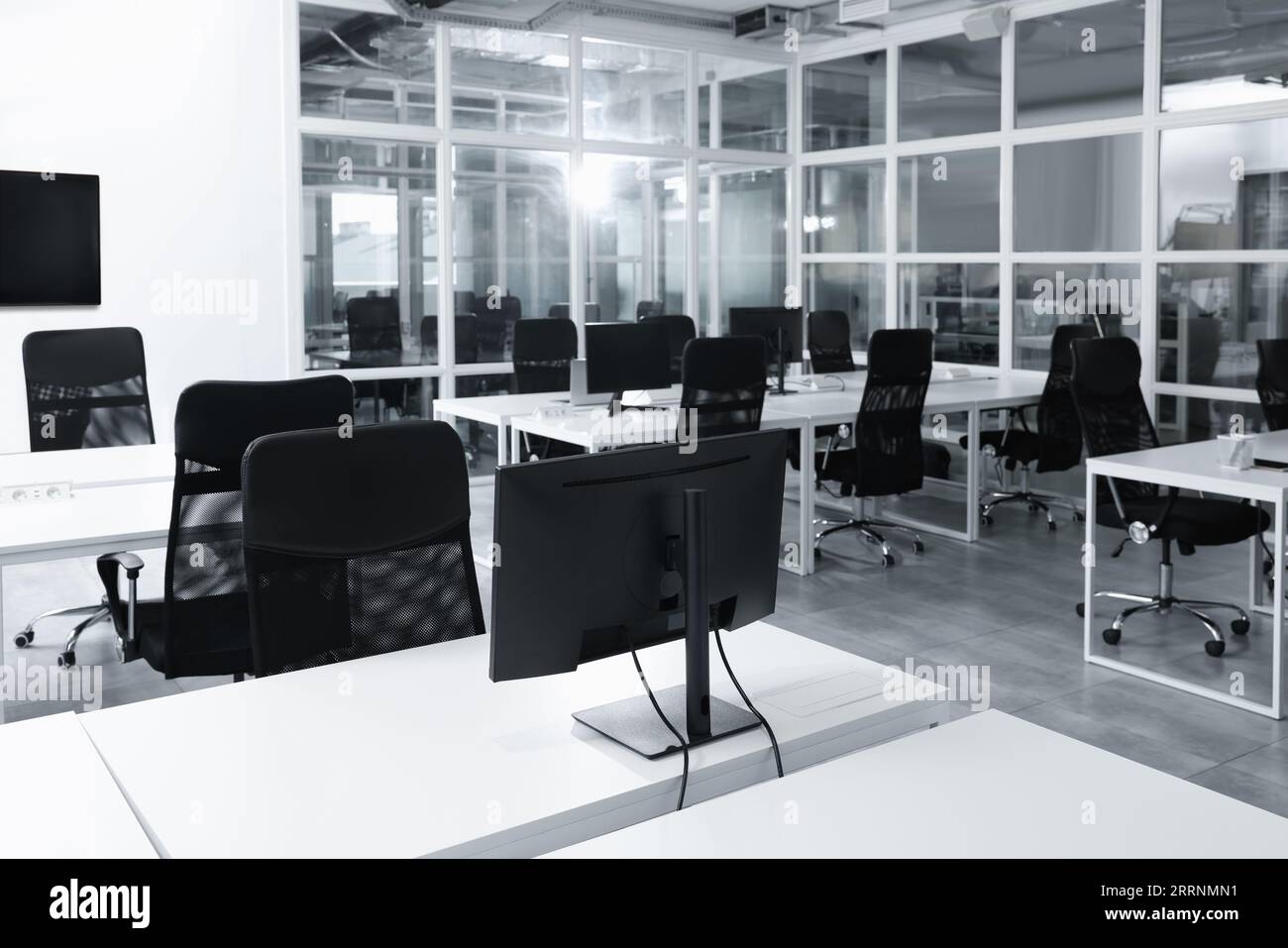 Stylish interior of open plan office. Workspace with computers, tables ...