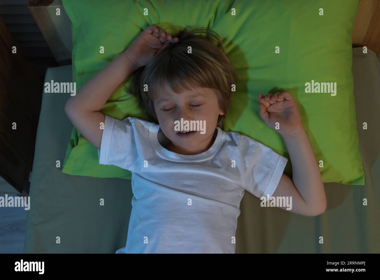 Little boy snoring while sleeping in bed at night, top view Stock Photo ...