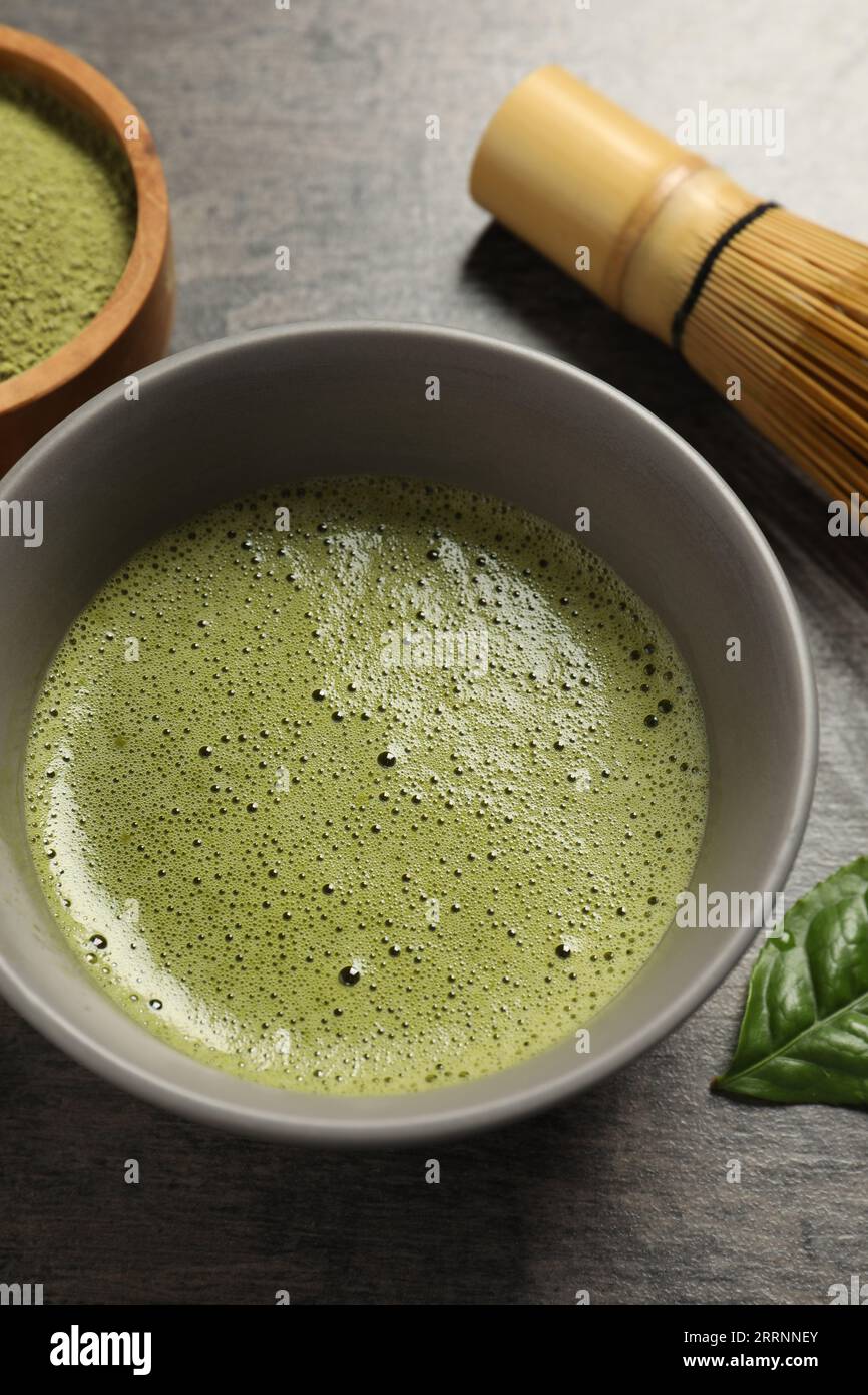 Cup of fresh matcha tea on dark grey table, above view Stock Photo - Alamy
