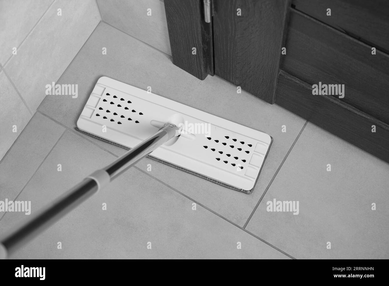 Cleaning grey tiled floor with mop, above view Stock Photo - Alamy
