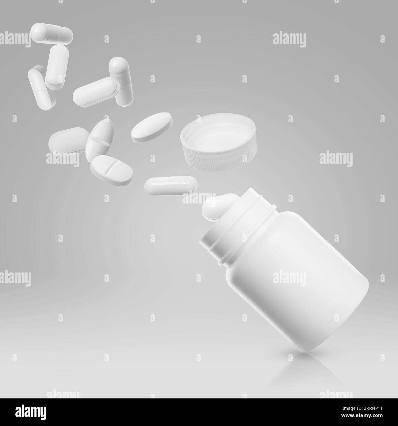 Many different white pills falling into bottle on light grey background ...