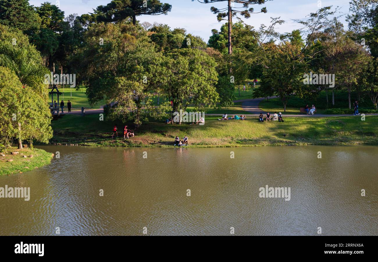 People gathered near the lake at the Botanical Garden of Curitiba Stock ...