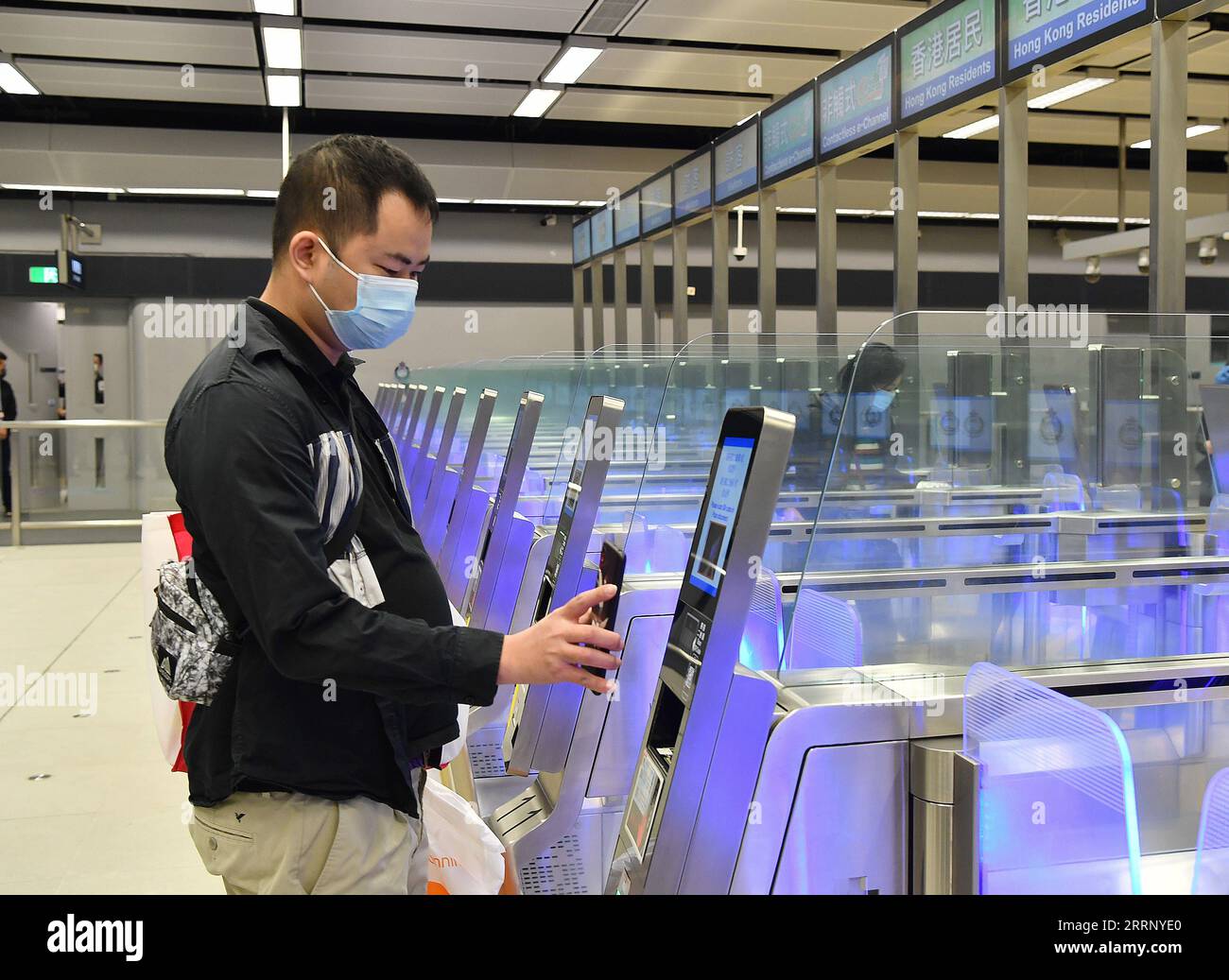 230206 -- HONG KONG, Feb. 6, 2023 -- A traveller passes the ticket gate ...