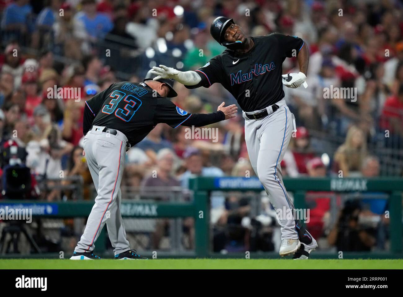 Miami Marlins' Jesus Sanchez, right, and third base coach Jody Reed ...