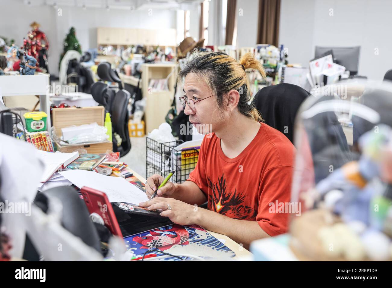 230210 -- HAIKOU, Feb. 10, 2023 -- Cartoonist Liu Ke works at an animation incubation base in ...
