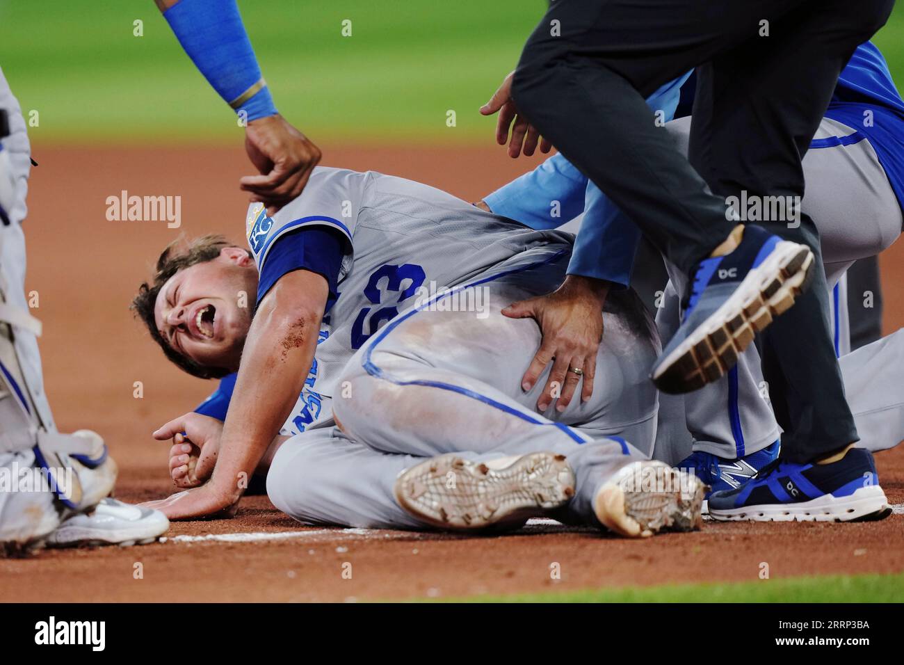 Kansas City Royals relief pitcher Austin Cox winces after an injury ...
