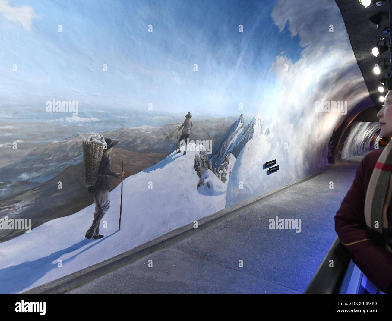 230215 -- GENEVA, Feb. 15, 2023 -- A Chinese tourists views a wall ...