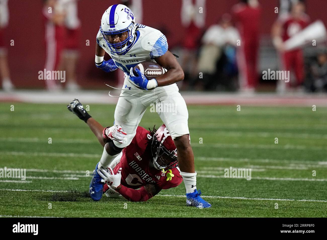 Indiana State running back Justin Dinka, top, is tackled by Indiana ...