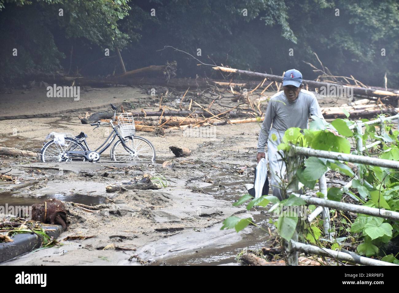 A man walks near a landslide site in Hitachi City, Ibaraki Prefecture ...