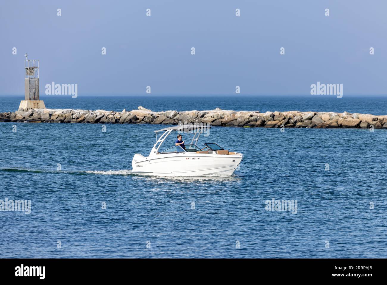 white cobalt bow rider coming into montauk inlet Stock Photo - Alamy