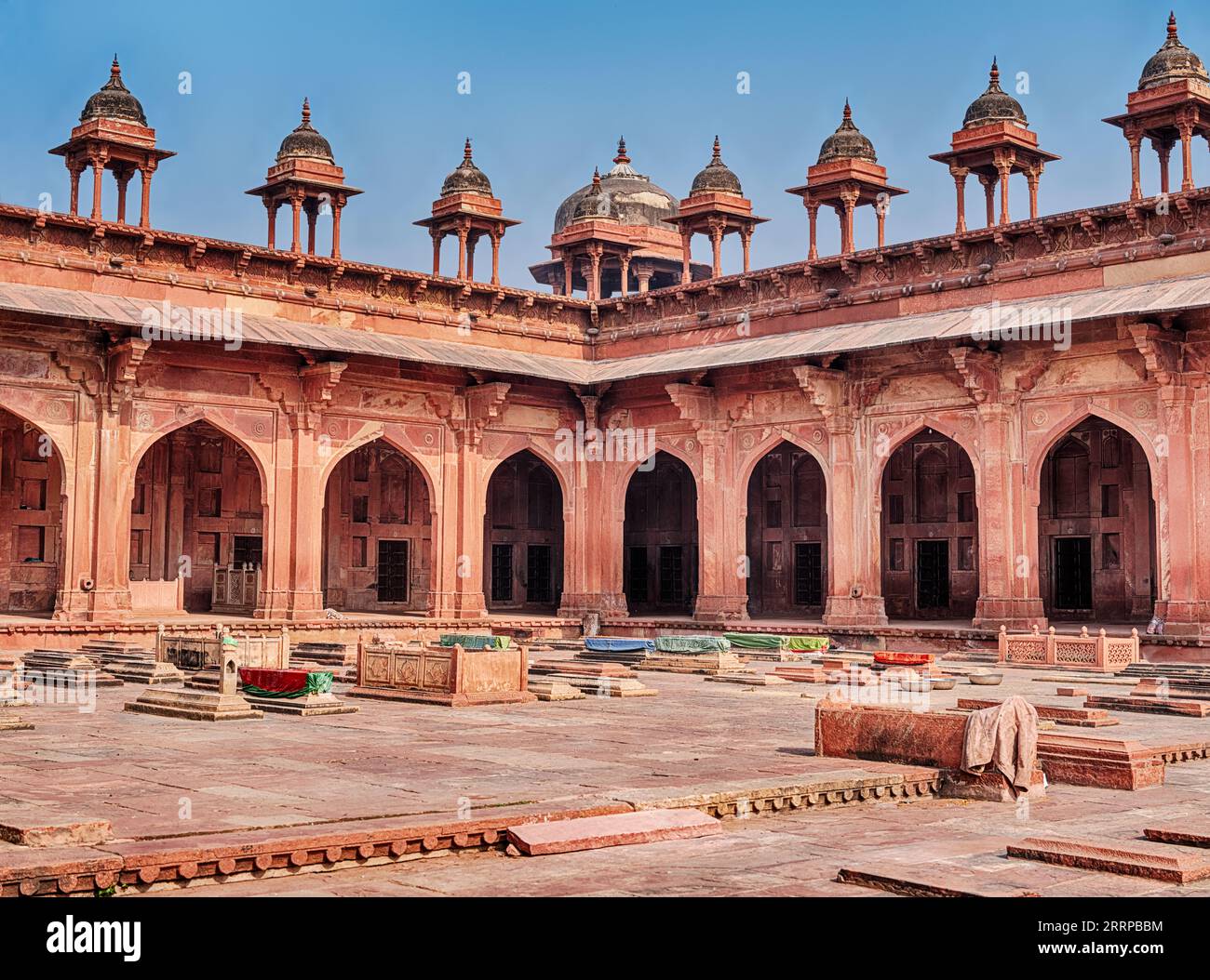 Tombs are scattered in a corner courtyard of the mosque at the historic ...