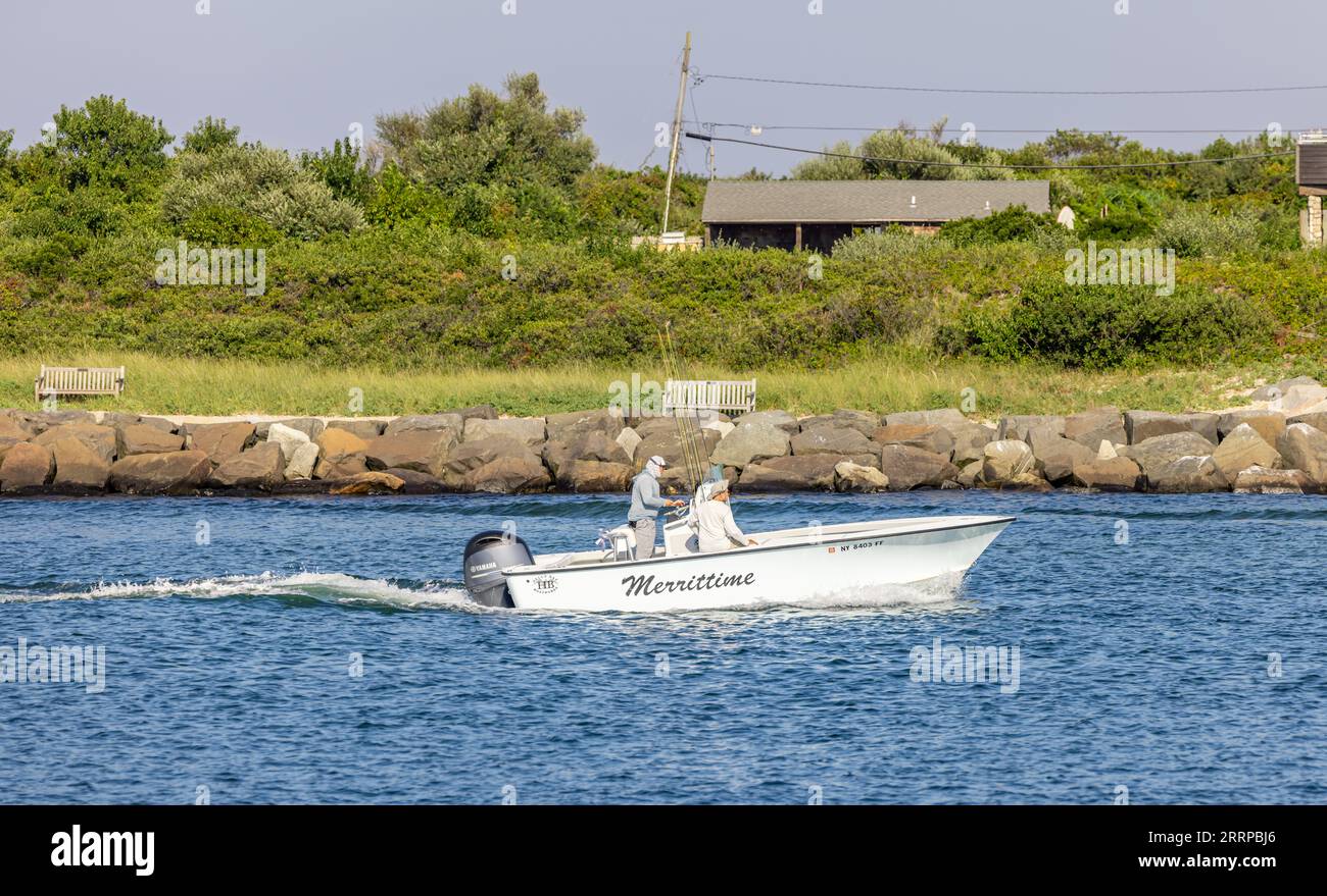 group of guys coming into montauk aboard teh merrittime outboard boat ...