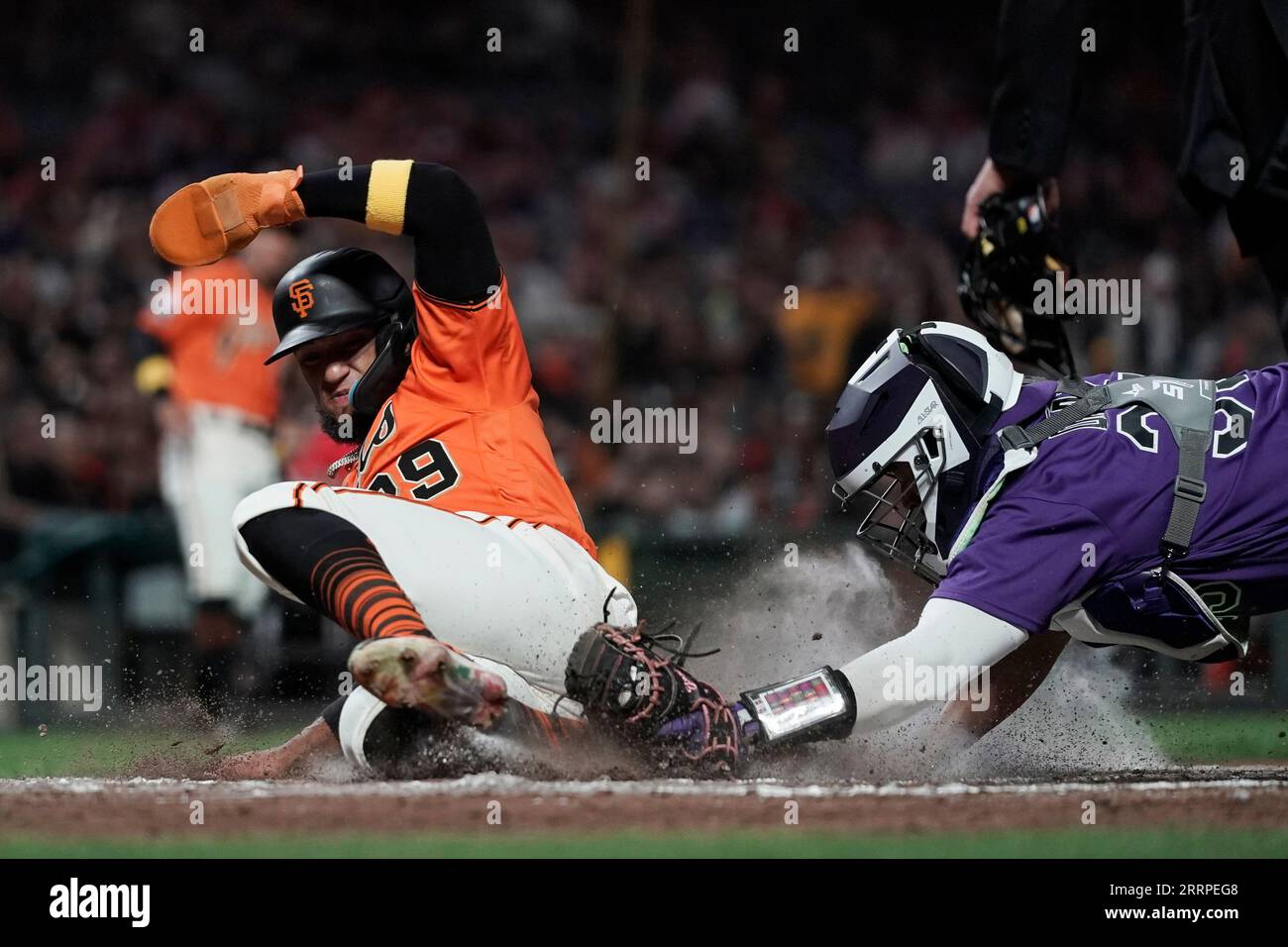 San Francisco Giants' Luis Matos, left, is tagged out by Colorado ...
