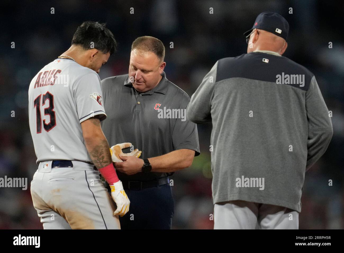 Cleveland Guardians' Gabriel Arias (13) is checked out for injury after ...
