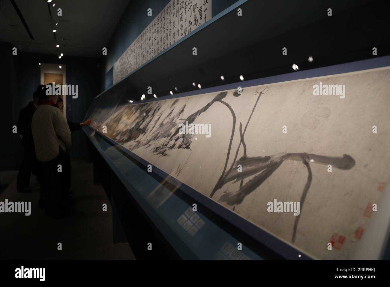 230326 -- NEW YORK, March 26, 2023 -- Visitors survey a masterpiece by ...