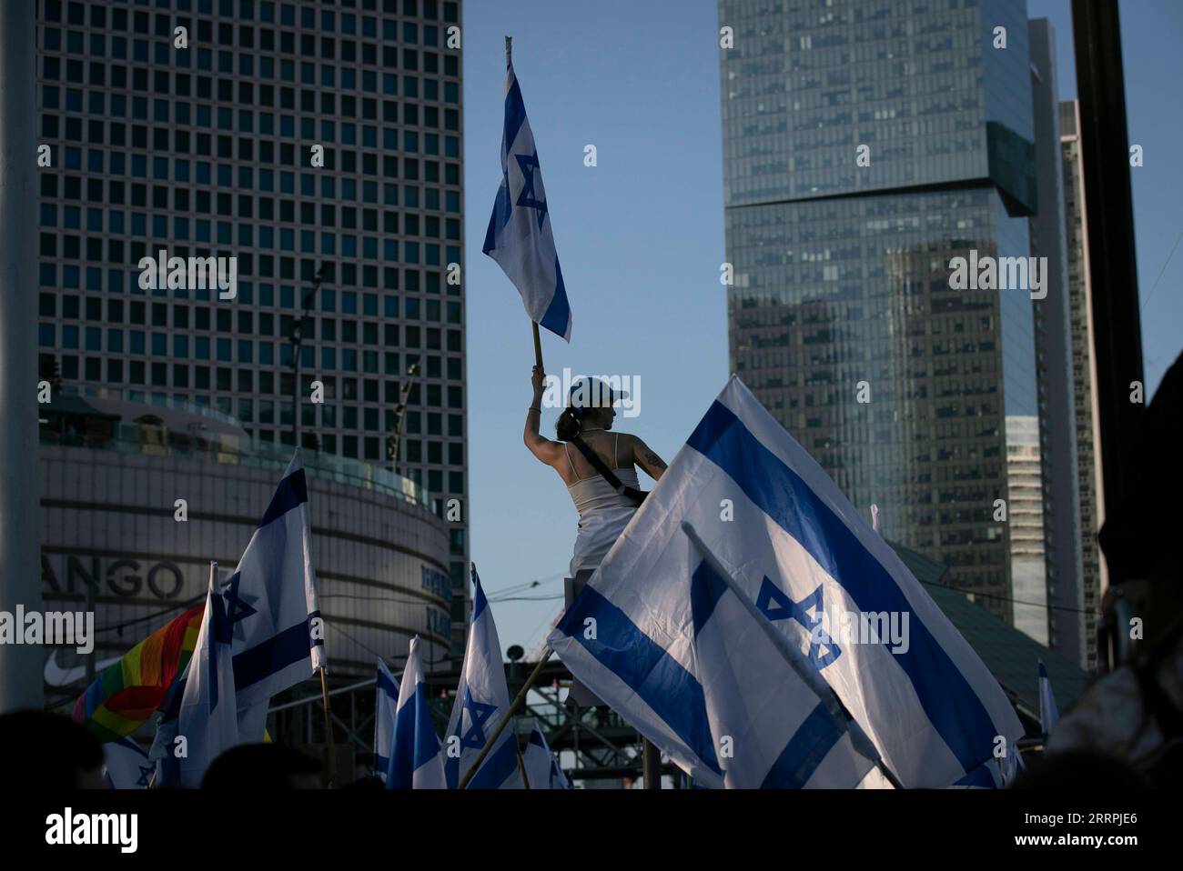 230327 -- TEL AVIV, March 27, 2023 -- A demonstrator holding an Israeli ...