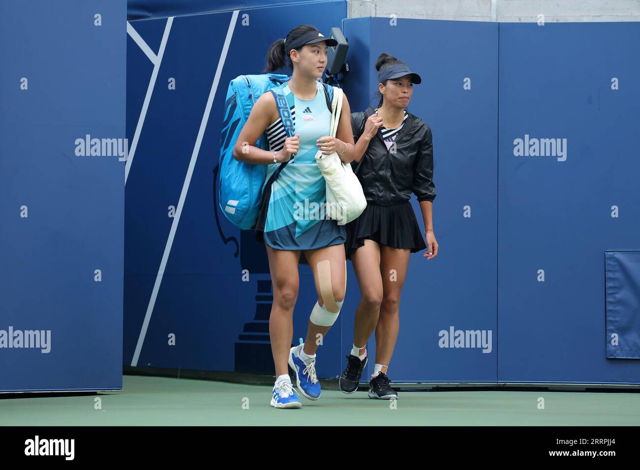 Xinyu Wang and Su-Wei Hsieh walk onto the court during a women's ...