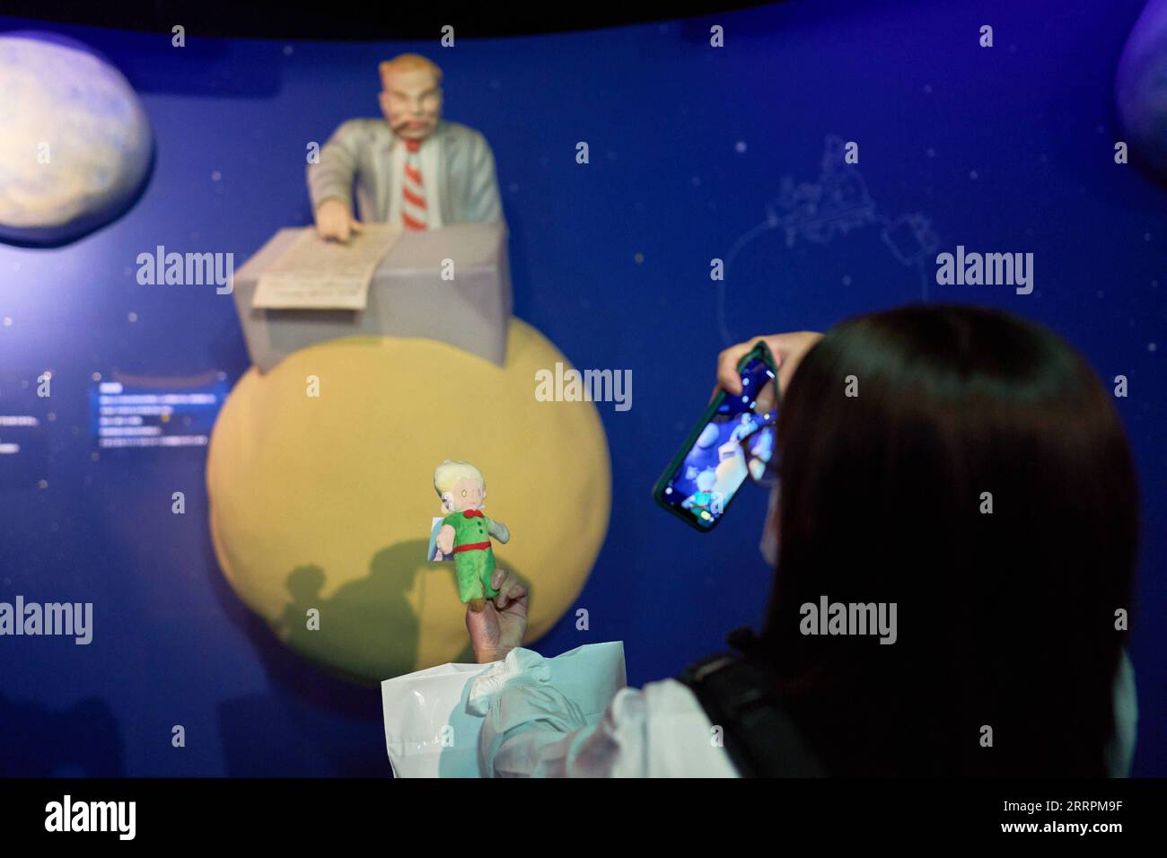 230401 -- HAKONE, April 1, 2023 -- A visitor takes pictures of a doll ...